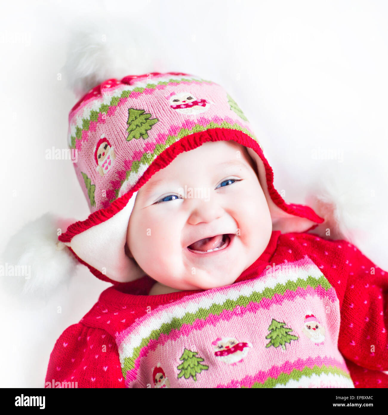 Happy laughing baby girl in a red dress with Christmas ornament Stock ...