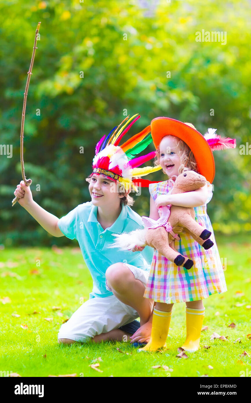 Two happy kids, laughing boy dressed as native American with colorful ...