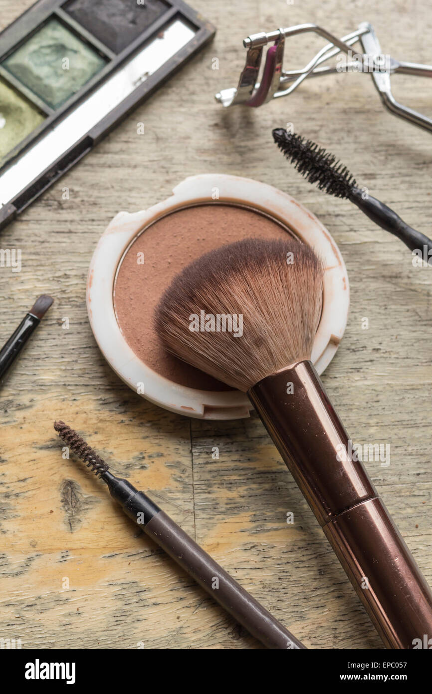 Used makeup kit on distressed wooden surface for beauty and cosmetics ...