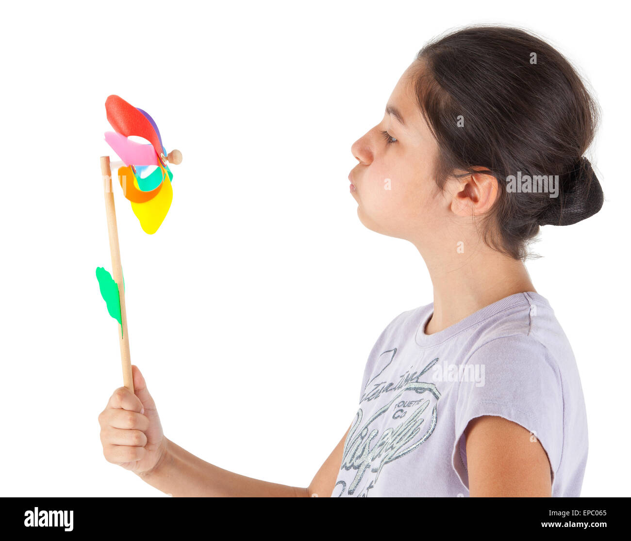 Teenager blowing a colored pinwheel on white background Stock Photo - Alamy