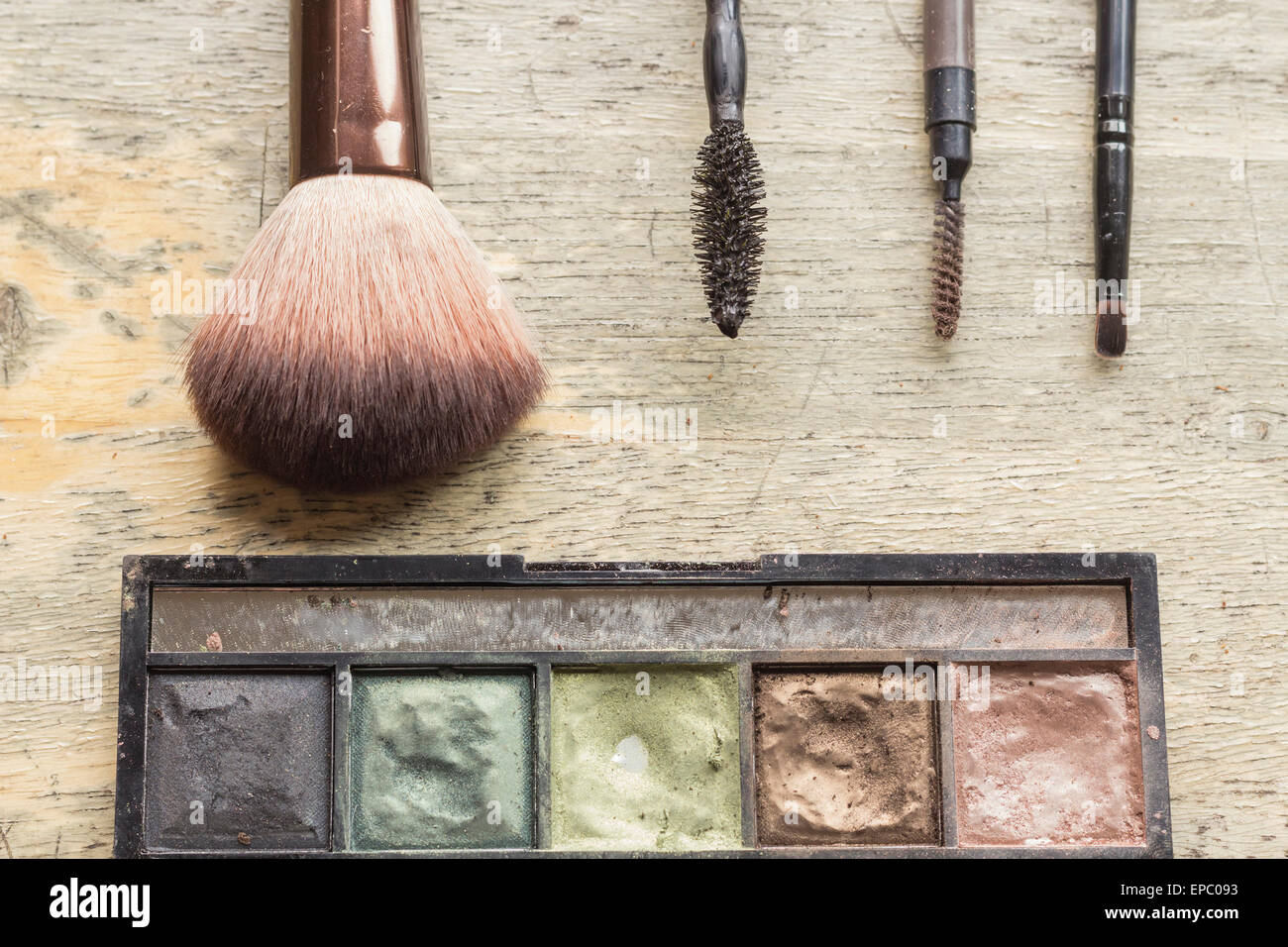 Used makeup kit on distressed wooden surface for beauty and cosmetics ...