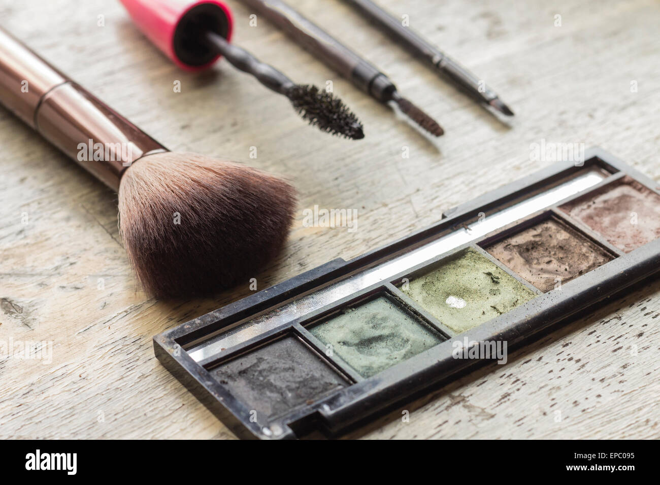 Used makeup kit on distressed wooden surface for beauty and cosmetics ...