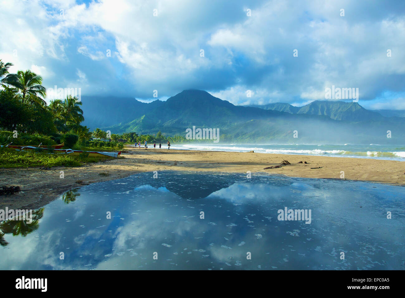 Tranquil water reflects rain clouds along the coast, Hanalei Bay; Kauai ...
