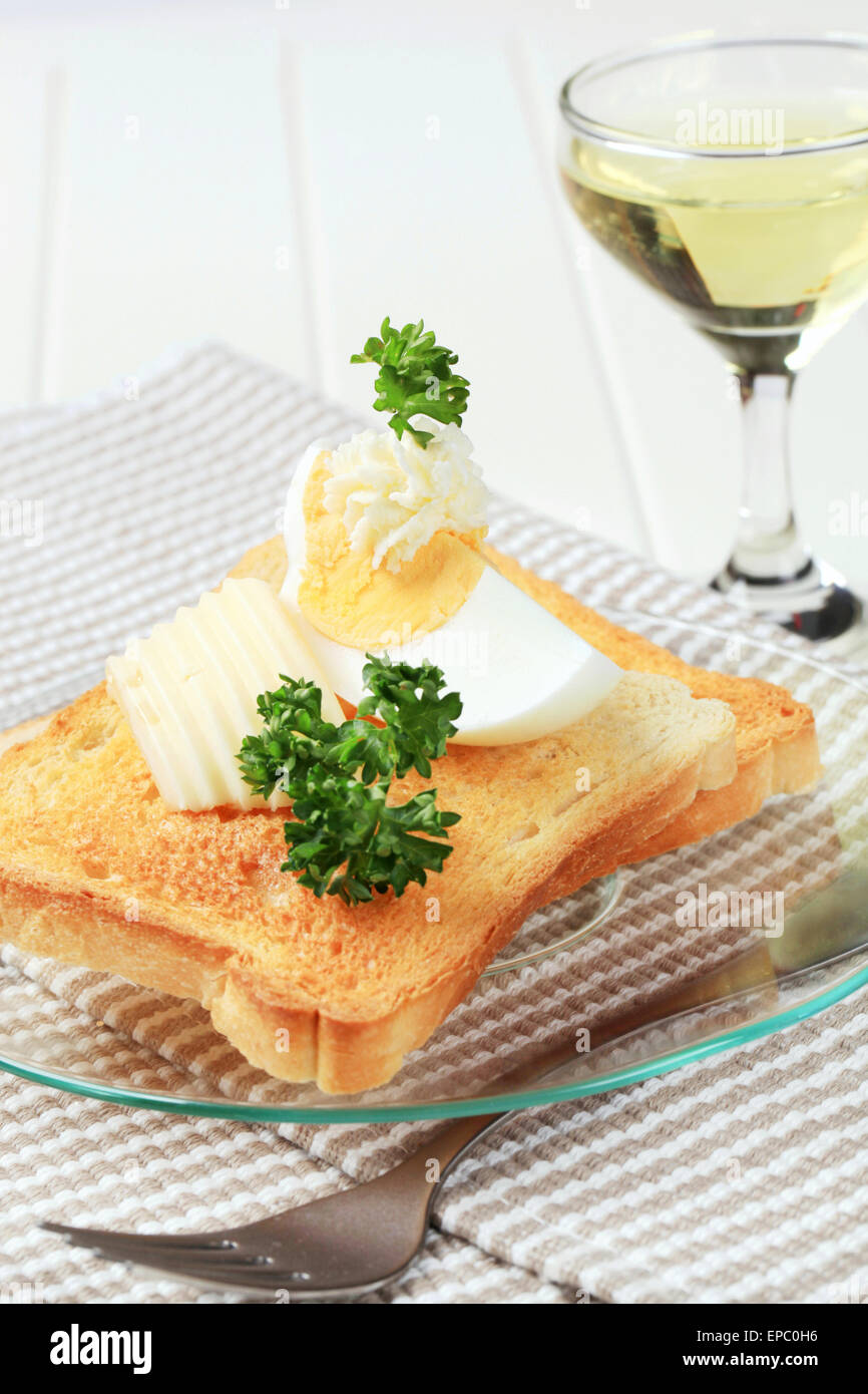 Two pieces of crispy toast with butter and boiled egg Stock Photo - Alamy
