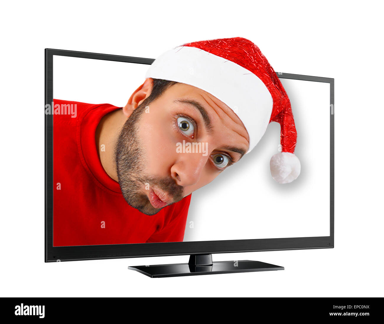 Young man with hat of Santa Claus comes out from the TV on white ...