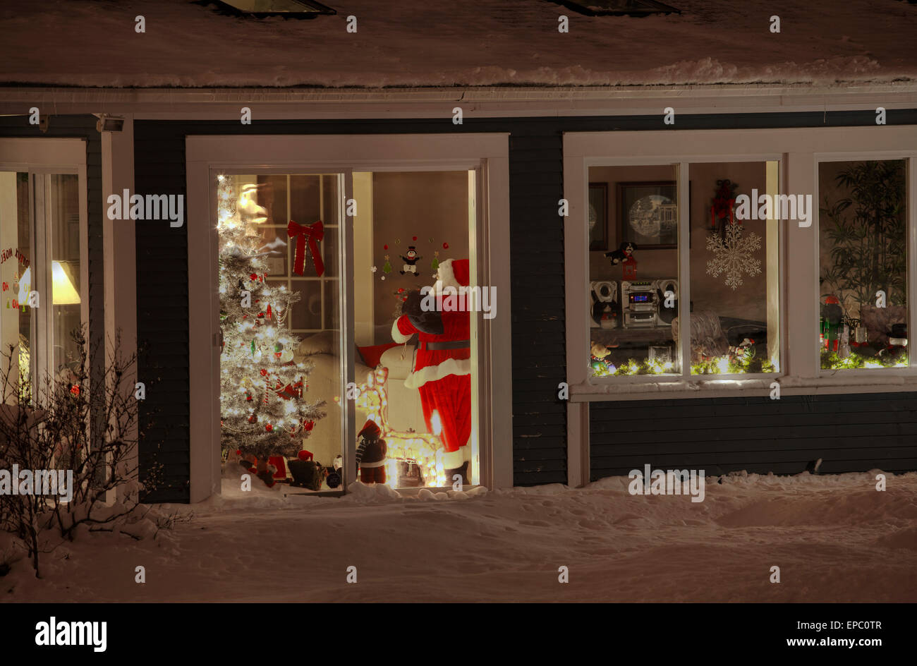 Santa Claus by the Christmas tree inside a house; Waterloo, Quebec ...