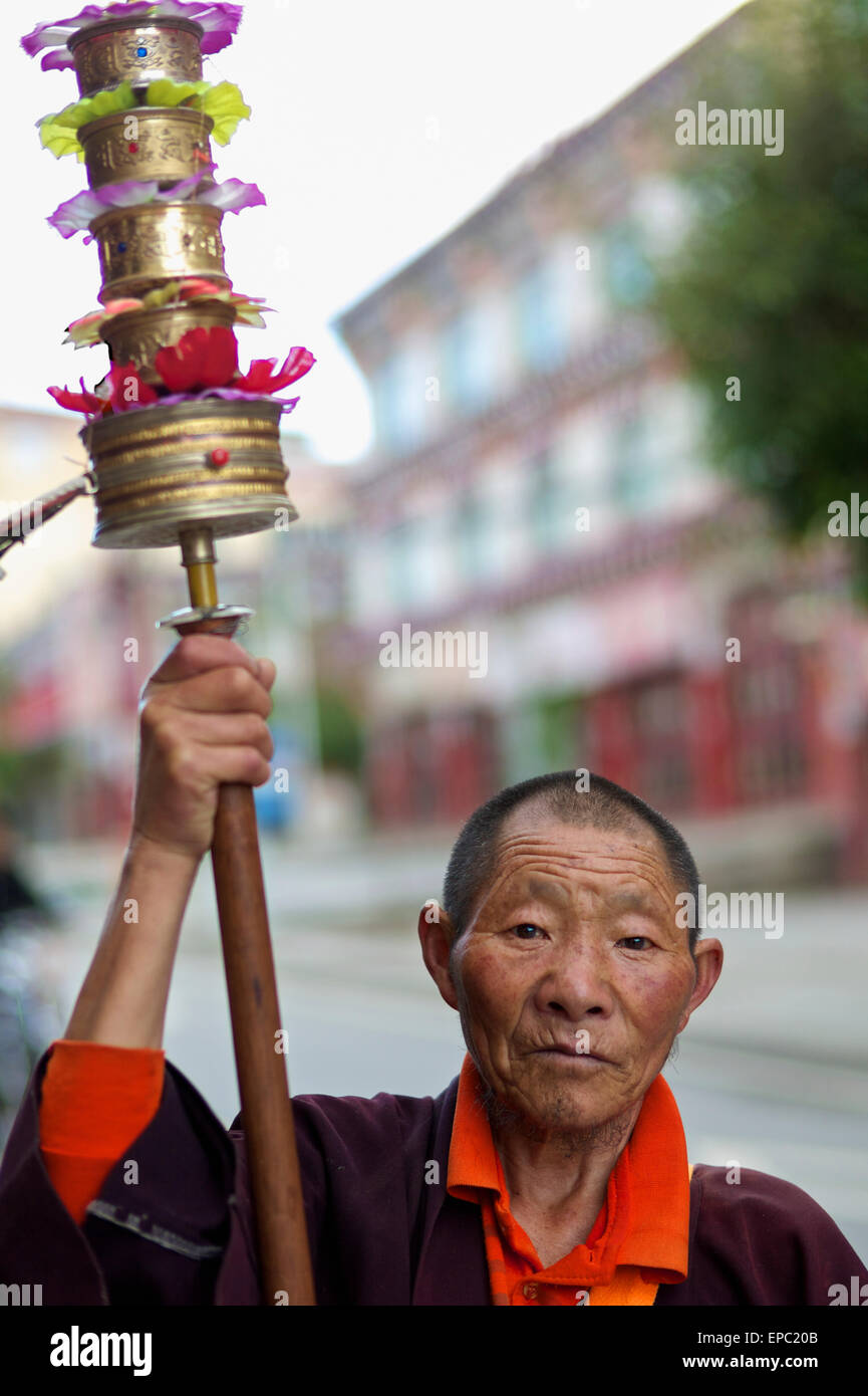 Tibetan man spins prayer wheel; Garze, Sichuan, China Stock Photo - Alamy
