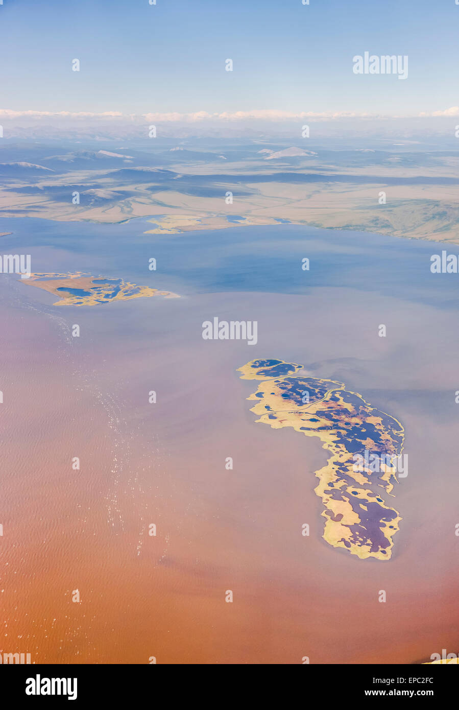 Aerial view of a small island in Hotham Inlet with the Baird Mountains ...
