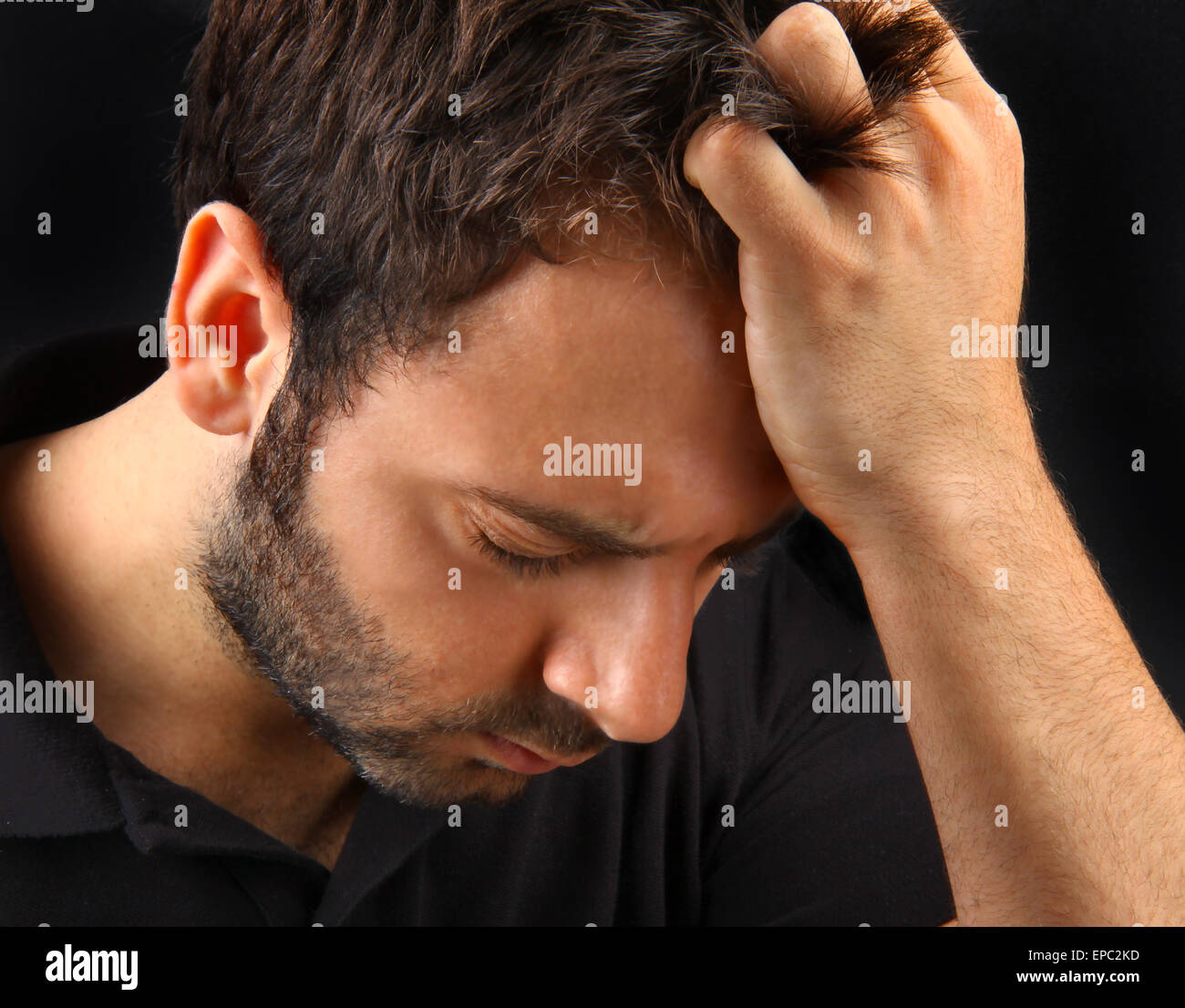 Man suffering a strong headache or depression pressing his forehead ...