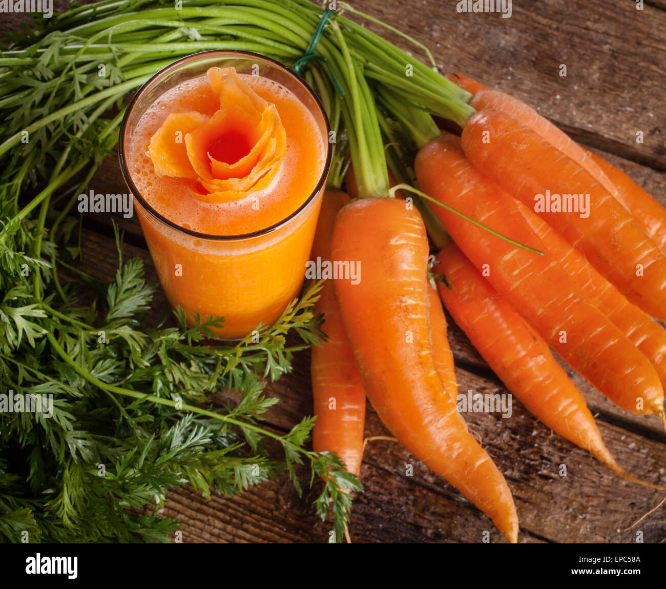 Fresh carrot juice glass with fresh organic carrots on wooden table ...