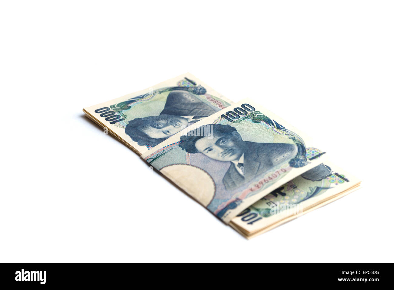 1,000 yen bills wrapped in a folded 1,000 yen bill isolated on white ...
