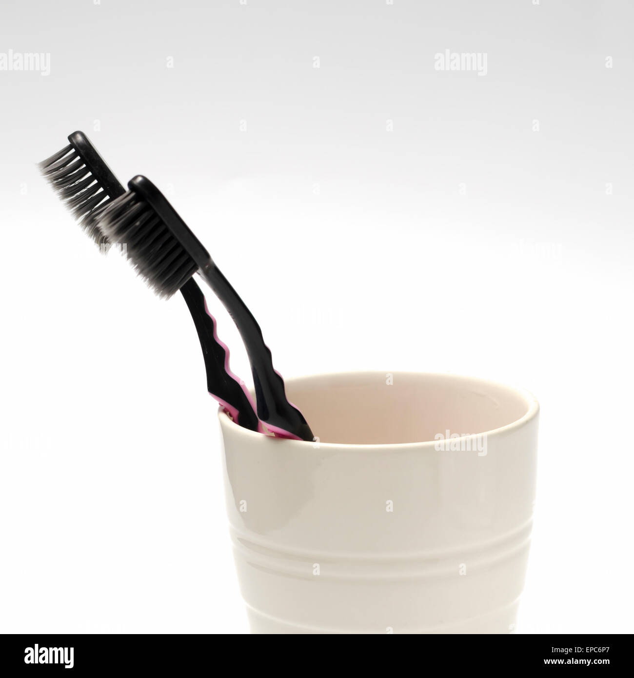 Tooth brushes in cup hi-res stock photography and images - Alamy