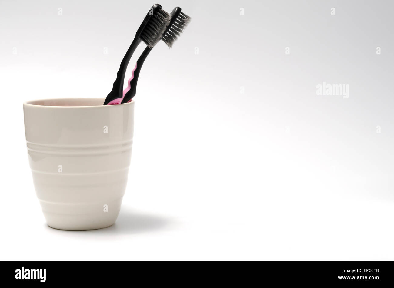 tooth brush in glass on a white background Stock Photo - Alamy