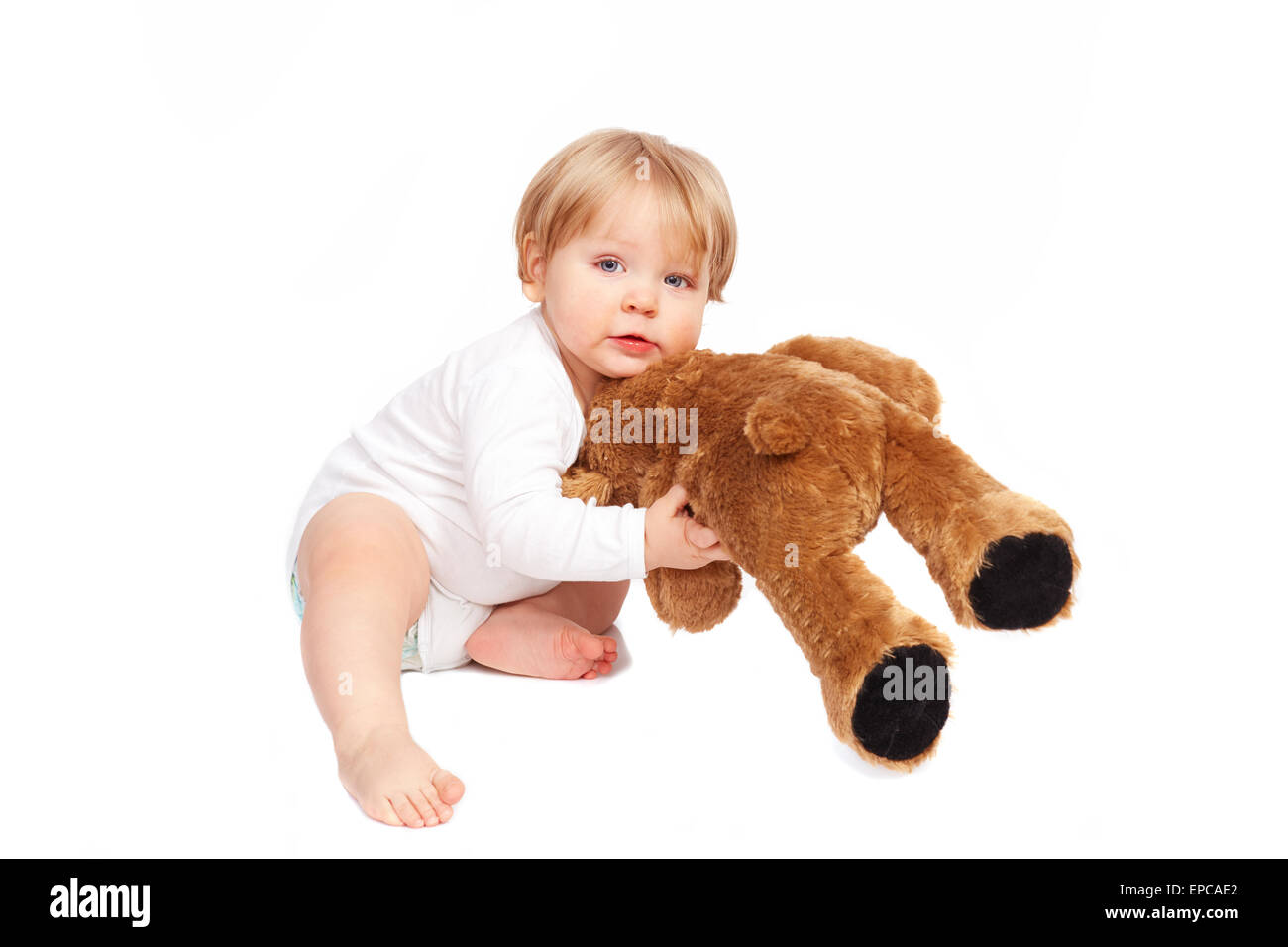 Little boy cuddling with his teddy bear Stock Photo - Alamy