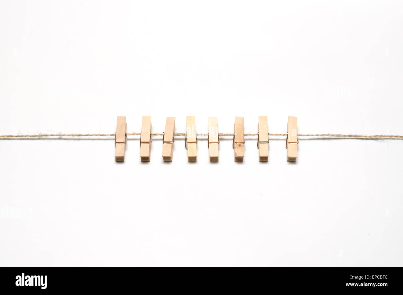 cloth pin hang with rope on a white background Stock Photo - Alamy