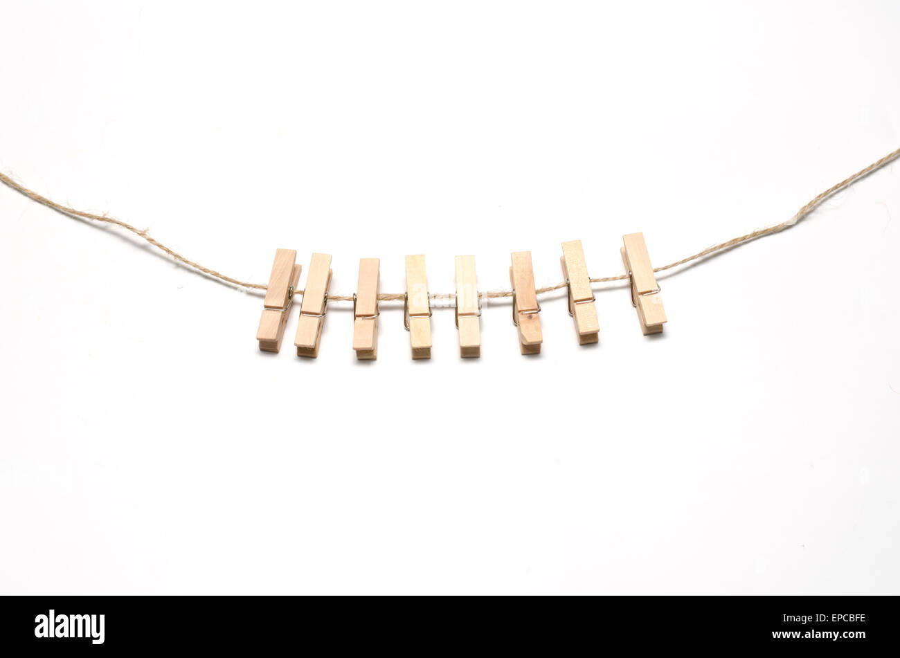 cloth pin hang with rope on a white background Stock Photo - Alamy