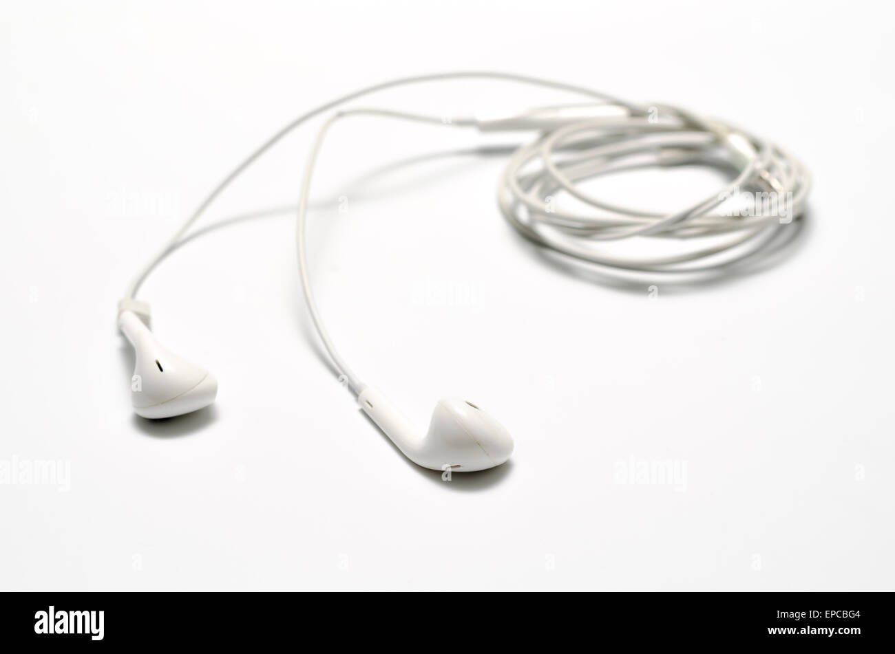 white earphones on a white background Stock Photo - Alamy