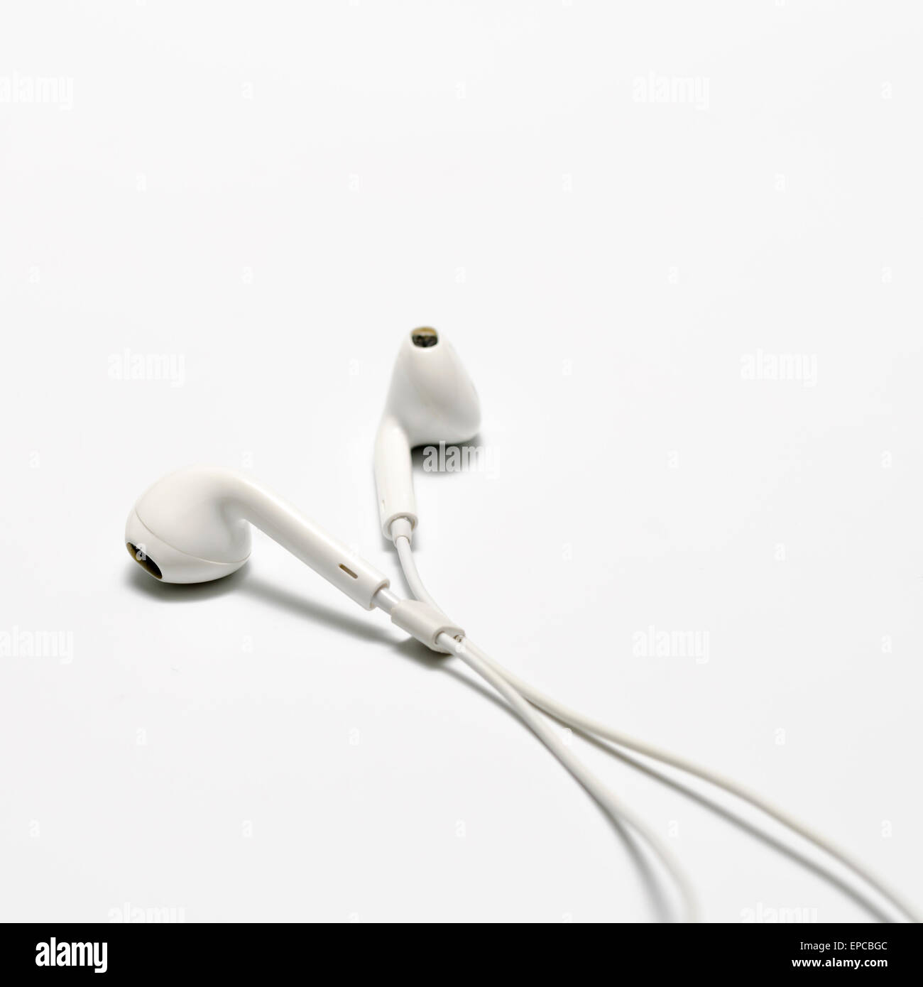white earphones on a white background Stock Photo - Alamy