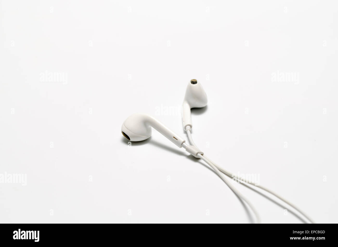 white earphones on a white background Stock Photo - Alamy