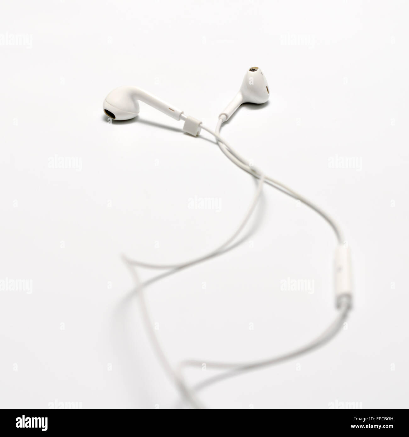 white earphones on a white background Stock Photo - Alamy