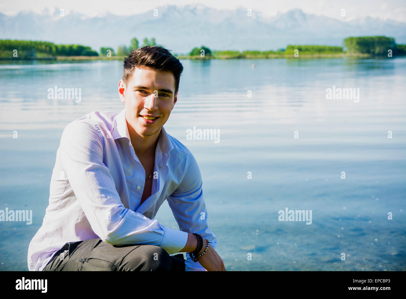 Man sitting on lake shore hi-res stock photography and images - Alamy