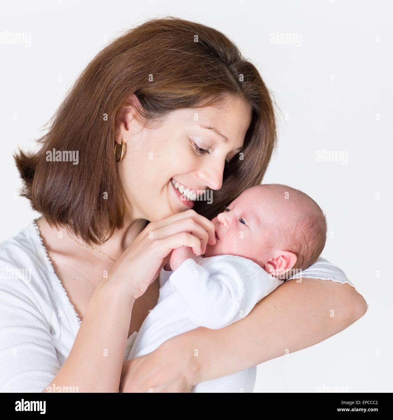 Young happy mother holding her newborn baby Stock Photo - Alamy