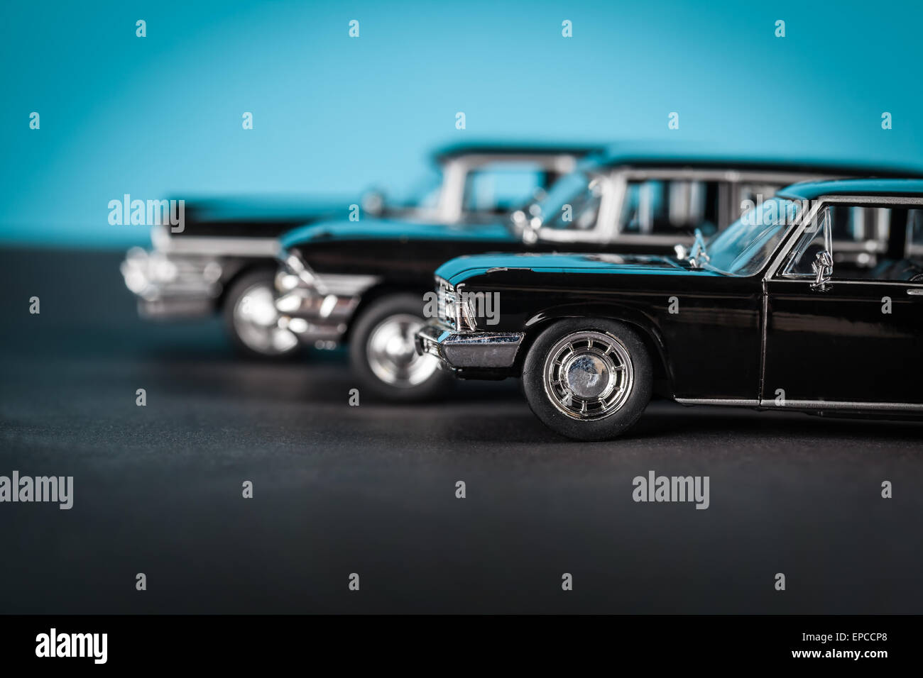 vintage toy cars standing sideways on blue background Stock Photo - Alamy