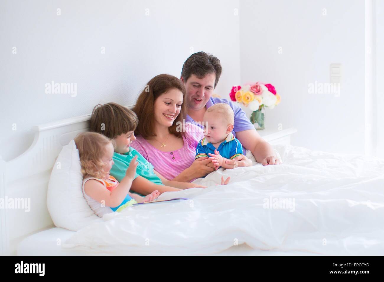 Happy big family, young parents with three kids, laughing boy, cute ...