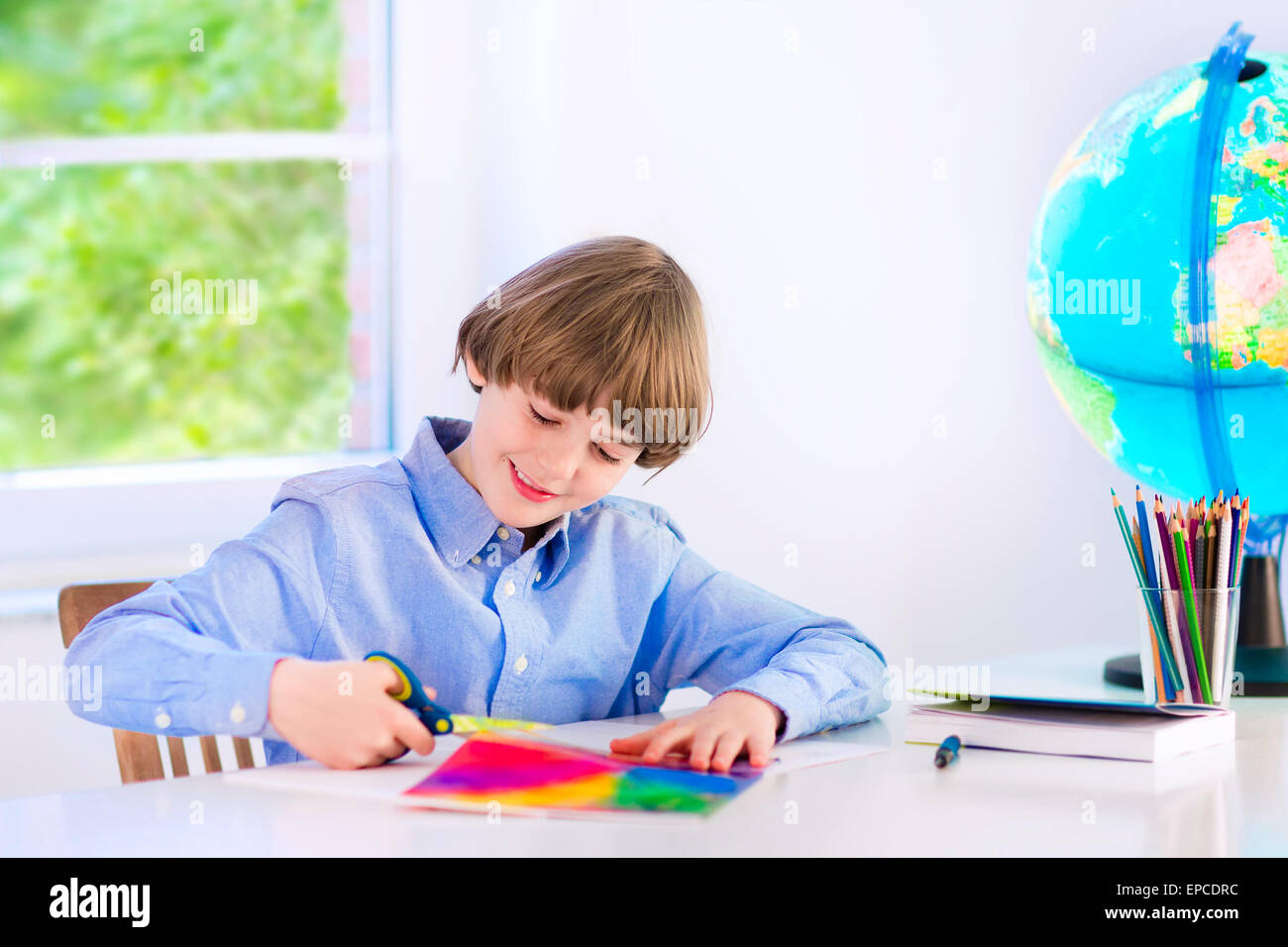 Boy cutting drawing scissors hi-res stock photography and images - Alamy