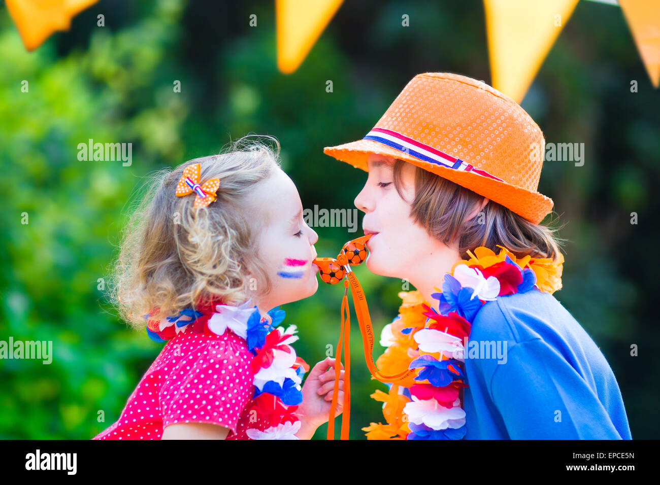 Two Dutch children, teenager boy and little girl, fans and supporters ...