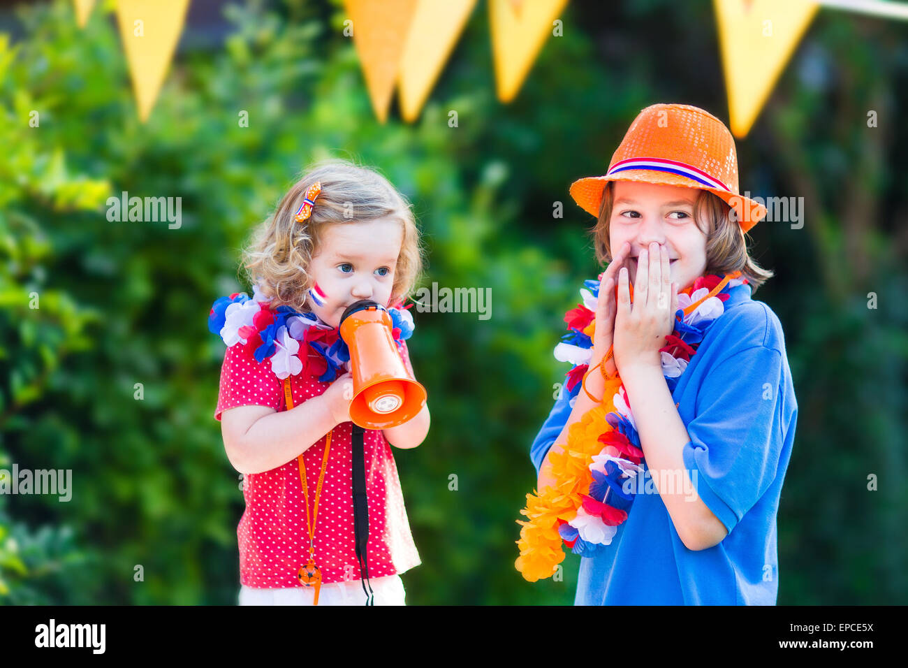 Two Dutch children, teenager boy and little girl, fans and supporters ...