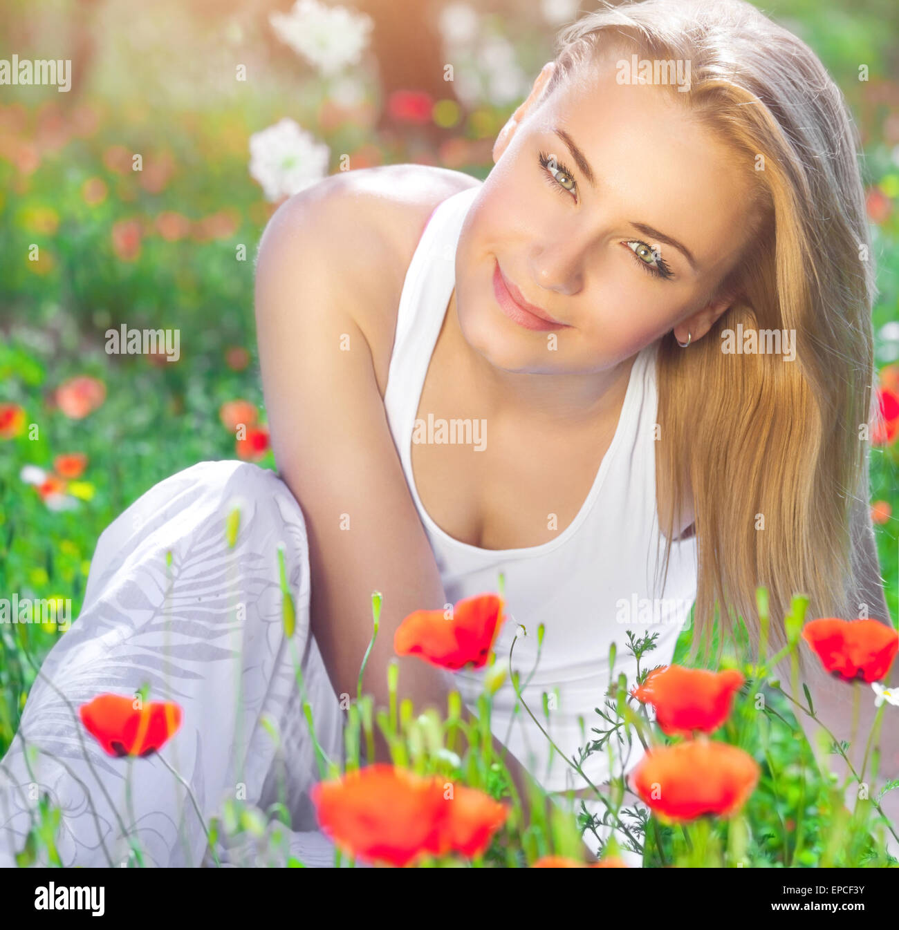 Beautiful woman sitting in poppy hi-res stock photography and images ...