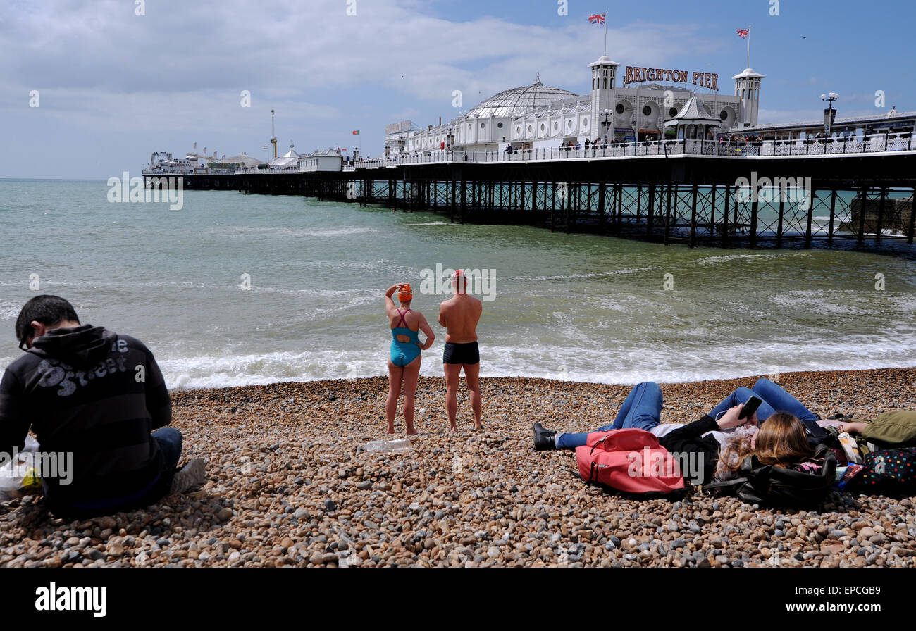 Brighton, UK. . Swimmers contemplate the sea on Brighton beach in ...