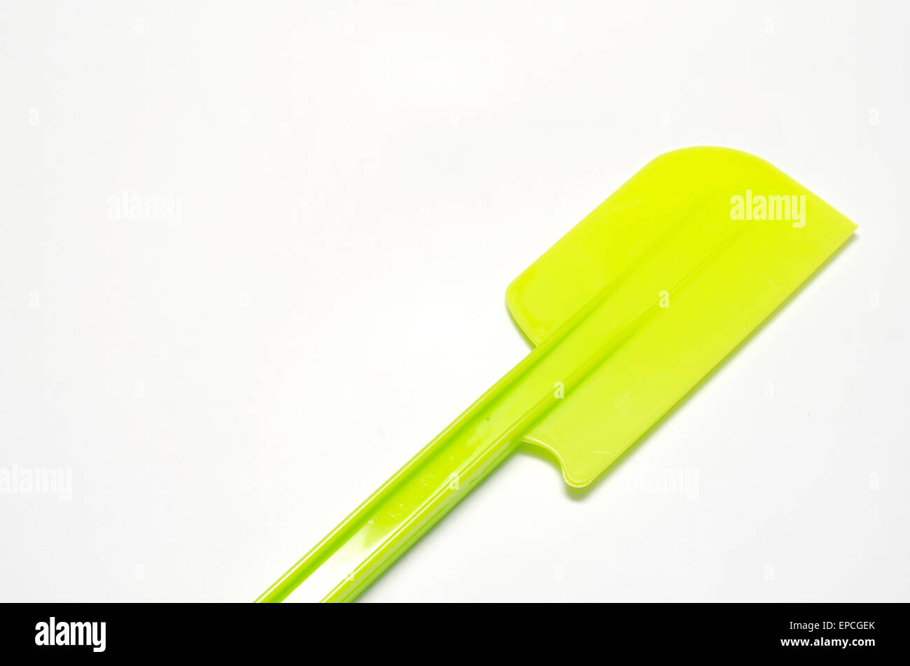 green plastic spatula on a white background Stock Photo - Alamy