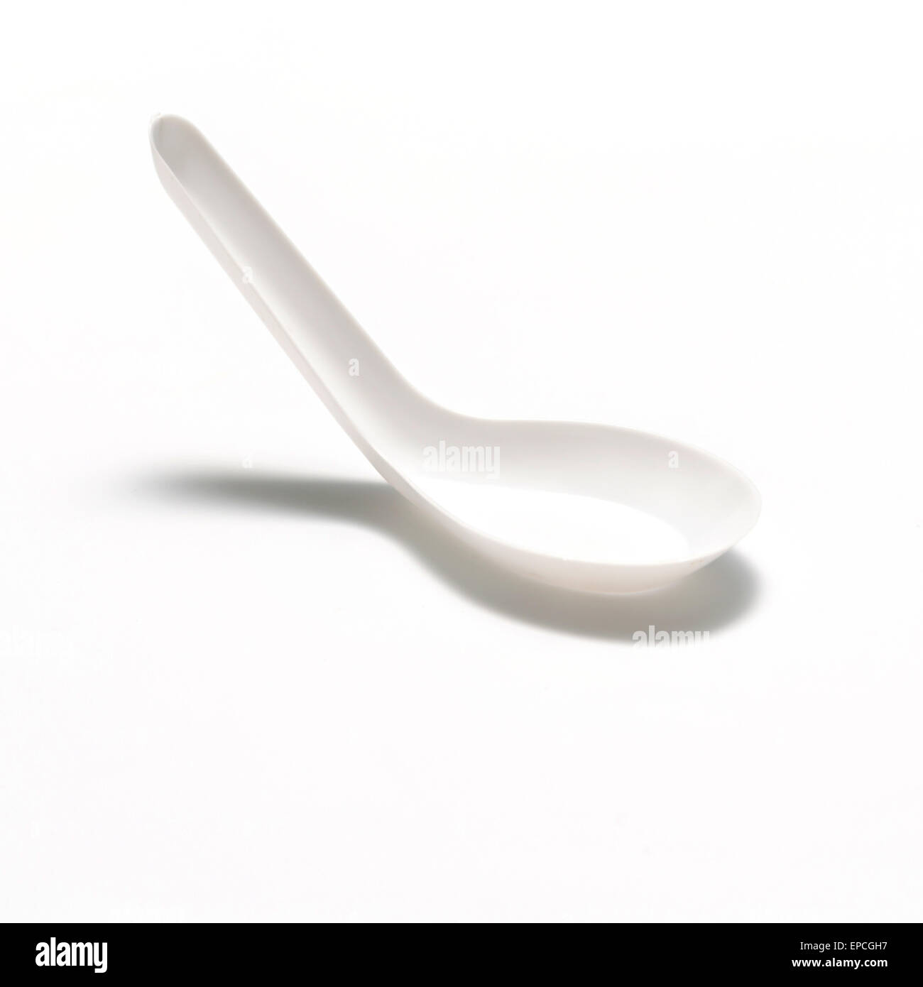 white plastic spoon on a white background Stock Photo - Alamy
