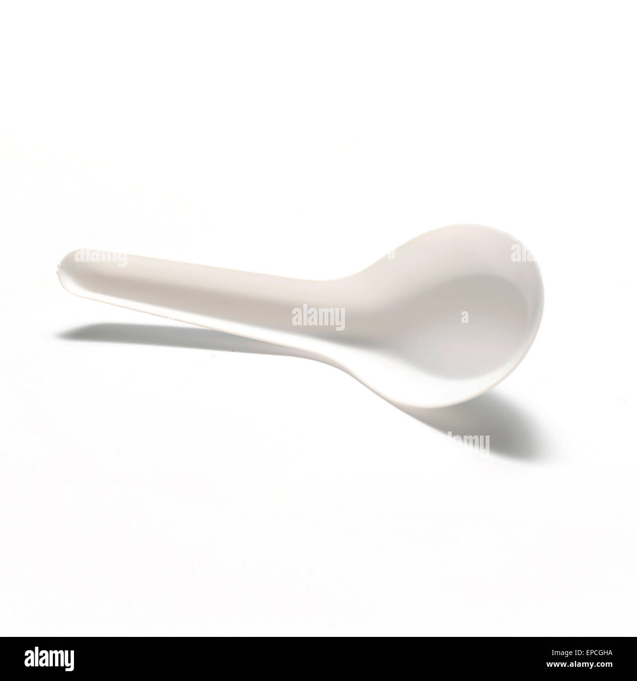 white plastic spoon on a white background Stock Photo - Alamy