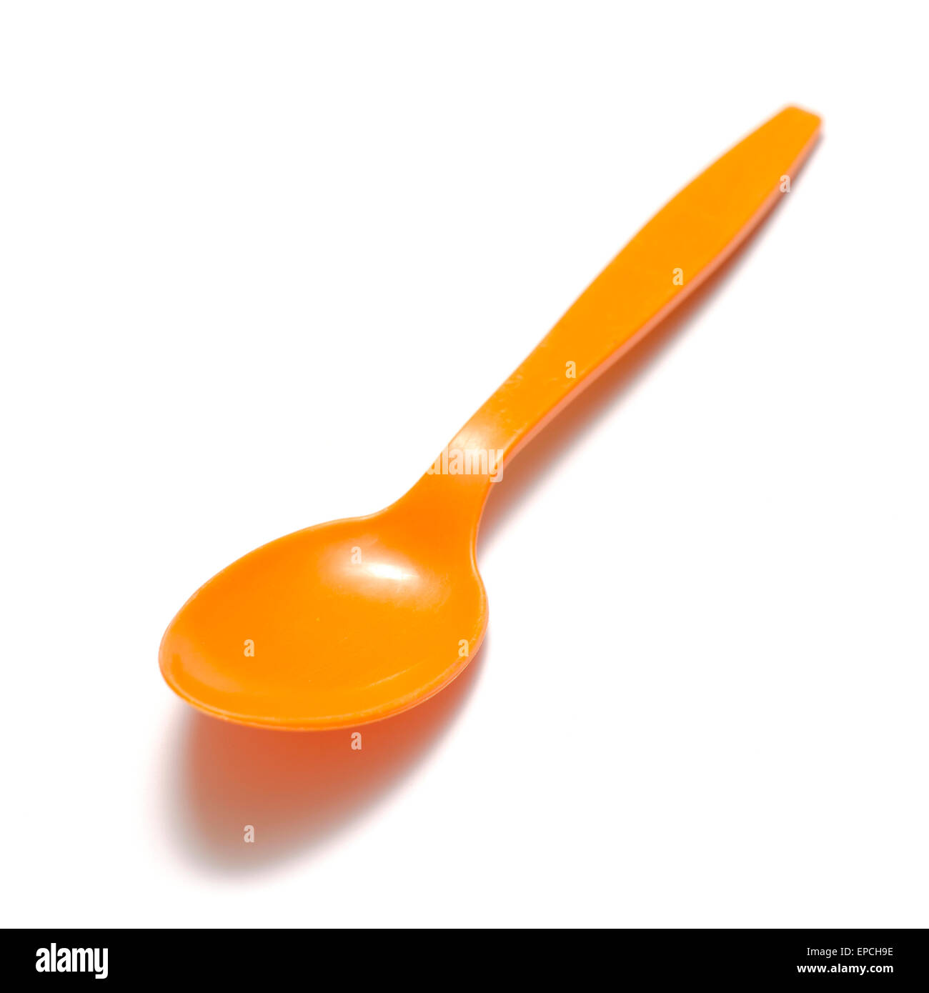 orange plastic spoon on a white background Stock Photo - Alamy