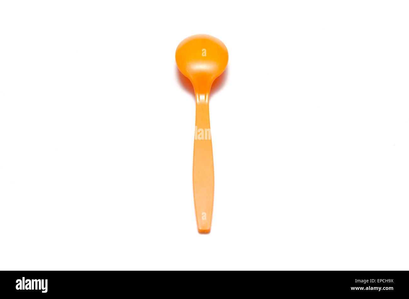 orange plastic spoon on a white background Stock Photo - Alamy