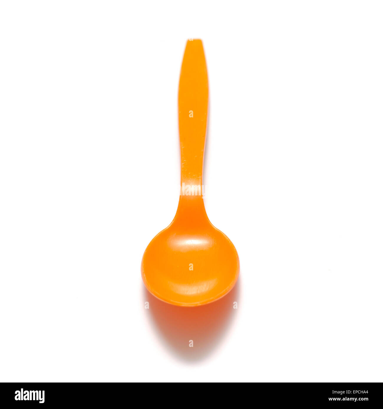 orange plastic spoon on a white background Stock Photo - Alamy