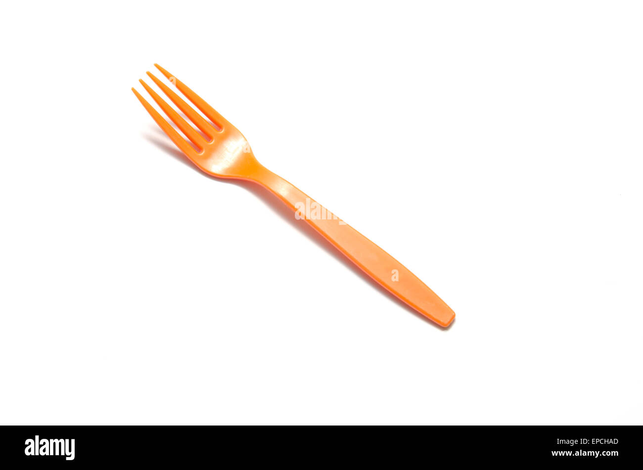 orange plastic fork on a white background Stock Photo - Alamy