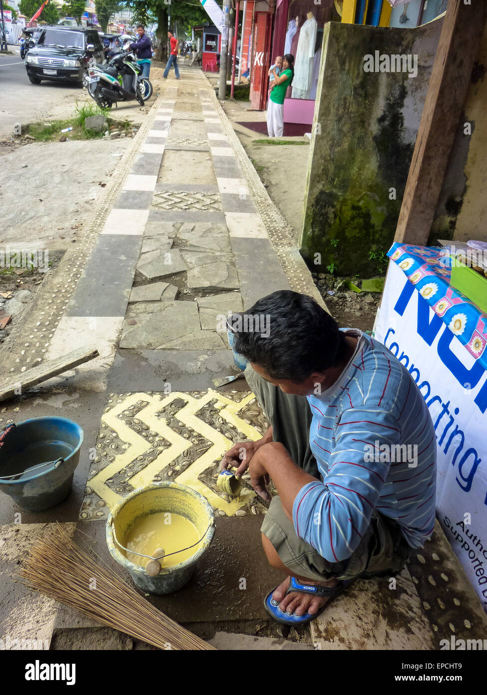 man repairing and painting pavement in manado sulawesi indonesia Stock ...