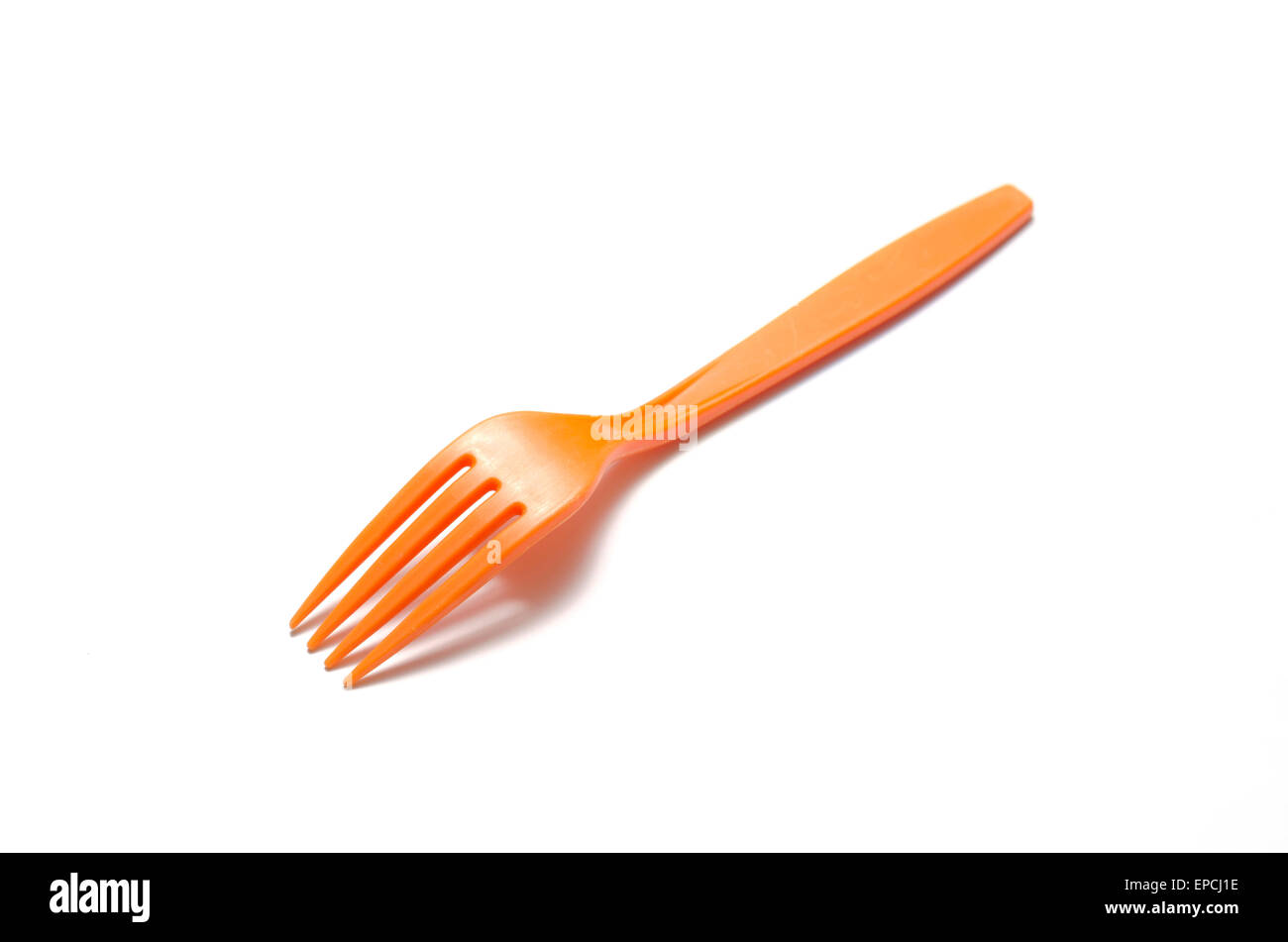 orange plastic fork on a white background Stock Photo - Alamy