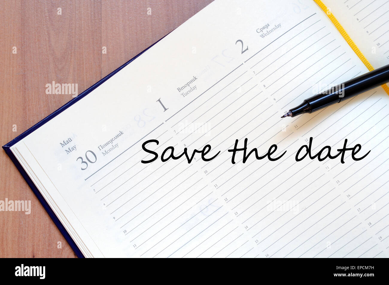 Yellow blank notepad on office wooden table Save the date concept Stock ...