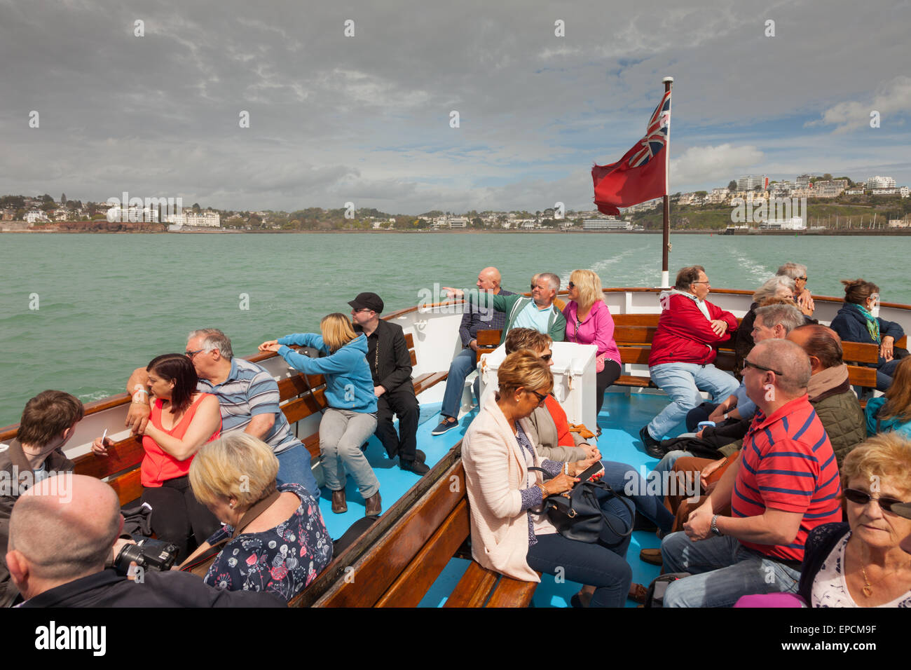 Tourists aboard a ferry crossing Torbay - from Torquay to Brixham ...