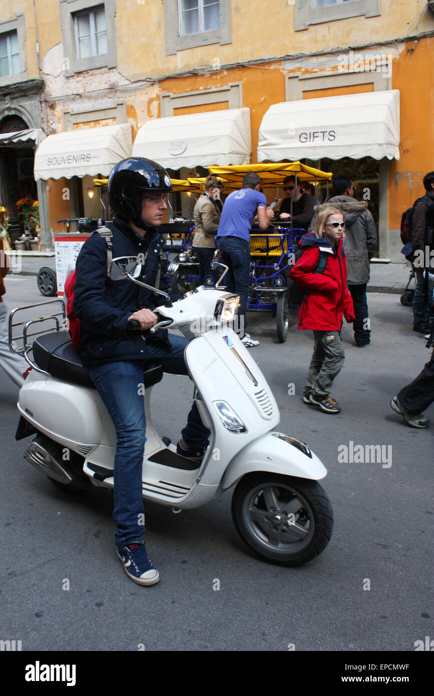 A man on white Vespa scooter in Pisa, Italy Stock Photo - Alamy