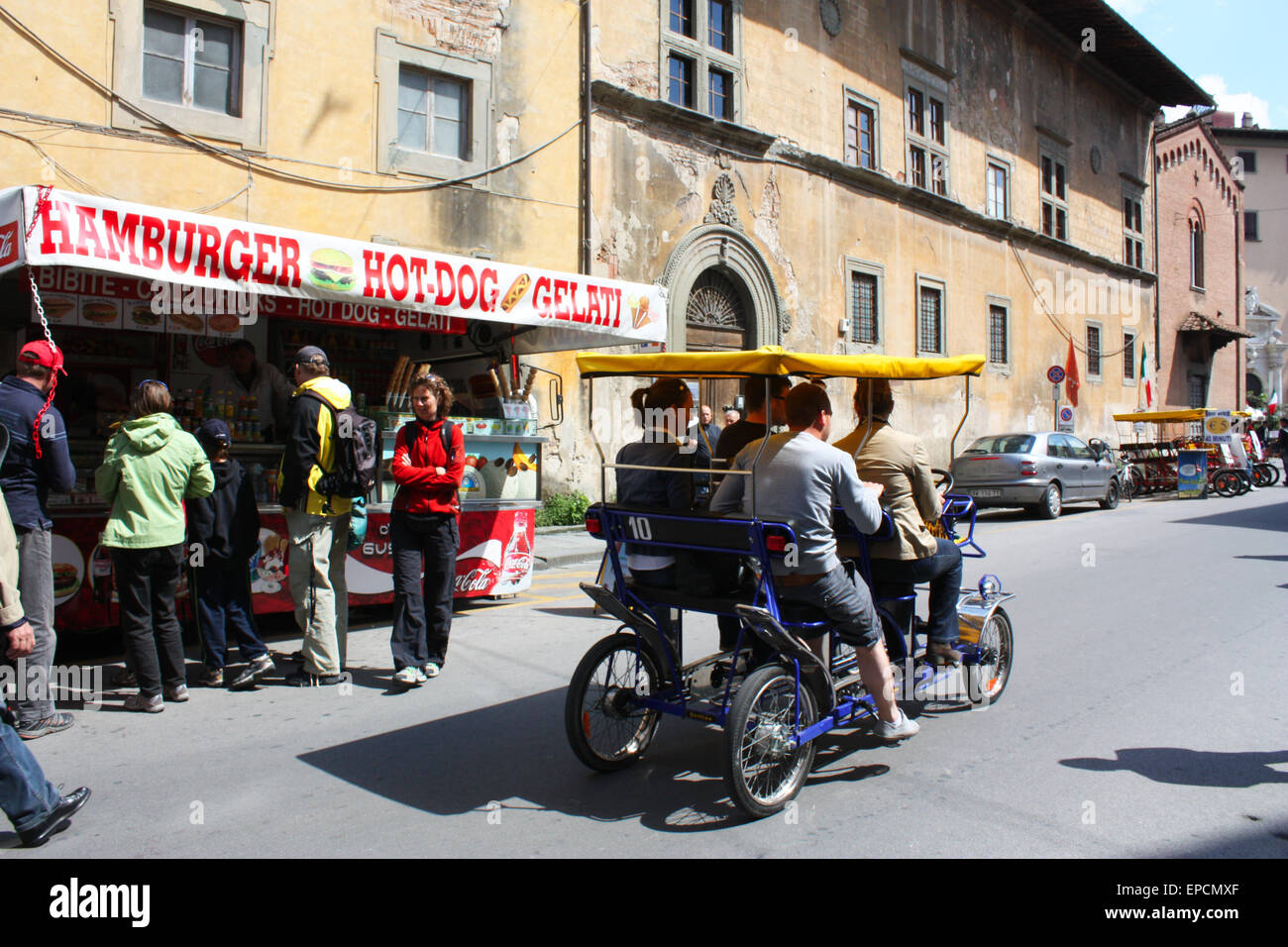 Tourists on four wheel cycle in Pisa, Italy Stock Photo - Alamy