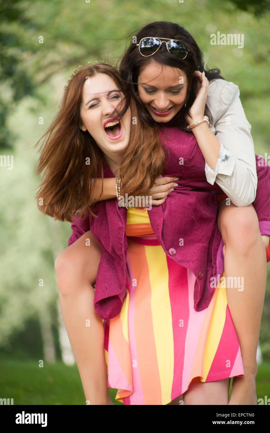 Two girls are having a lot of fun in the forest Stock Photo - Alamy
