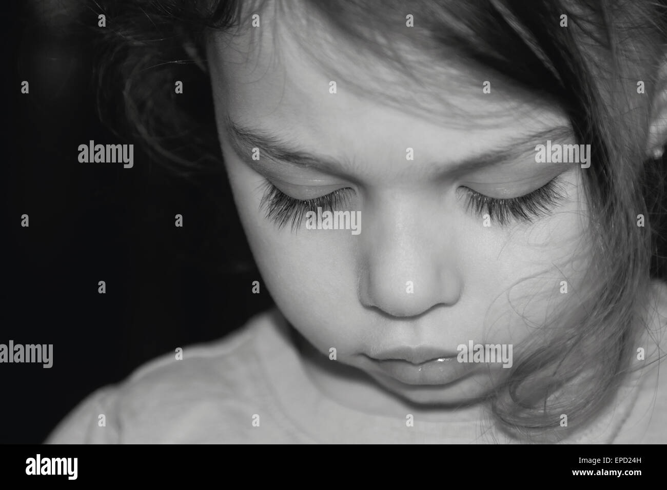 Toddler girl in deep thought Stock Photo - Alamy