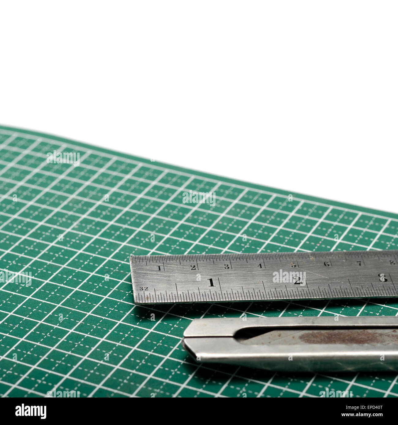ruler and cutter on green cutting mat Stock Photo - Alamy