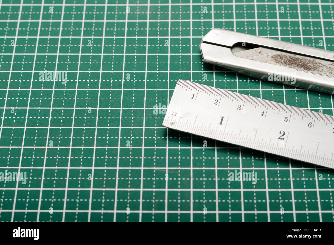 ruler and cutter on green cutting mat Stock Photo - Alamy